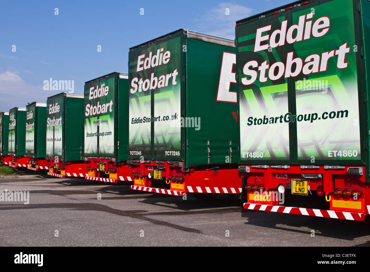 Row of Parked Eddie Stobart trucks trailers & containers at Lorry Halt ...