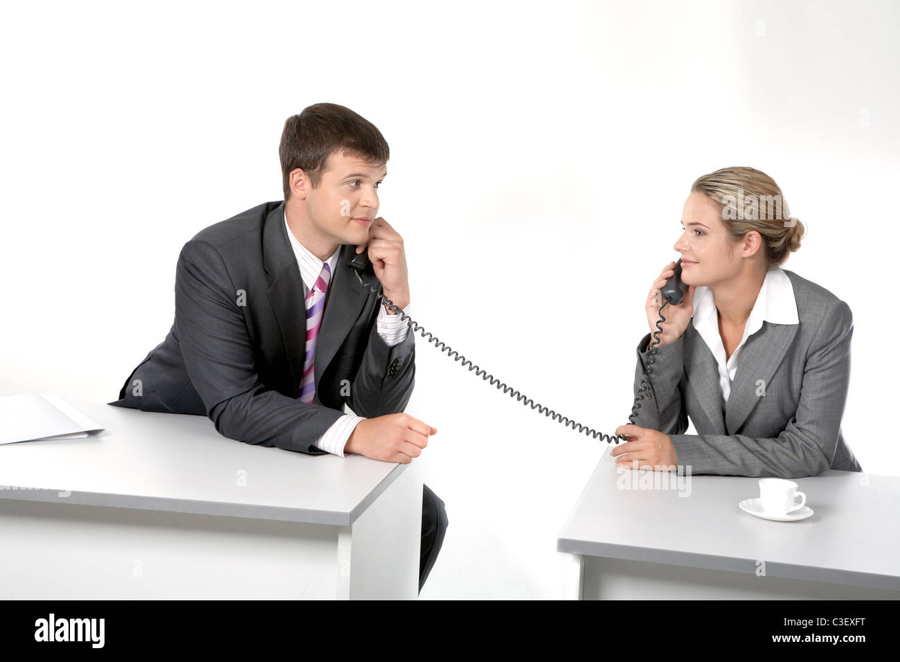 Portrait of business partners speaking on the telephone in office Stock ...