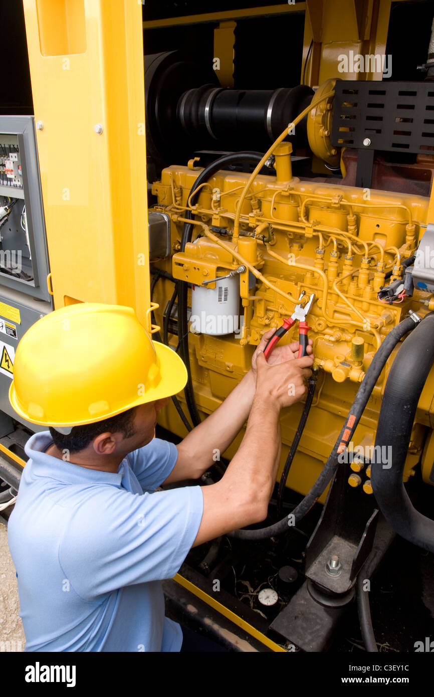 Technician is fixing the problem on generator Stock Photo - Alamy