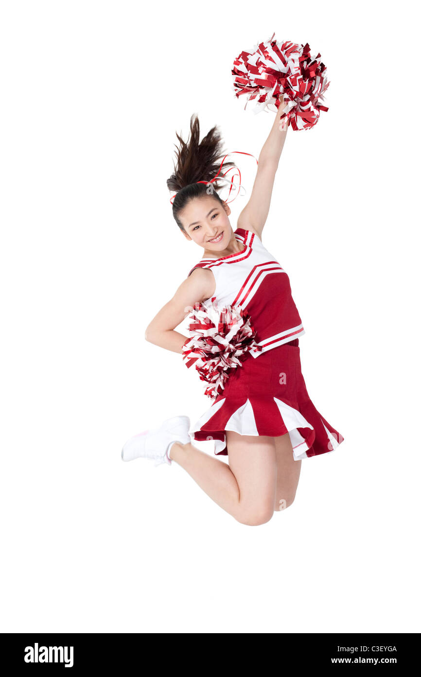 Smiling cheerleader jumping in mid air hi-res stock photography and ...
