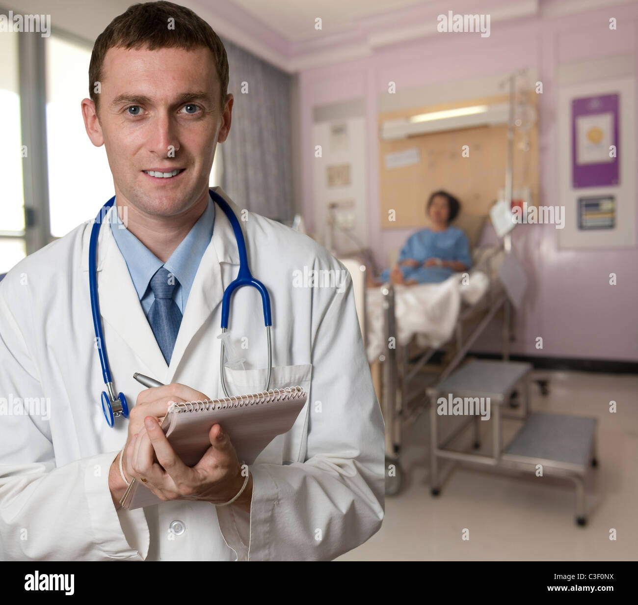 Young Doctor writing prescription for patient in hospital Stock Photo ...