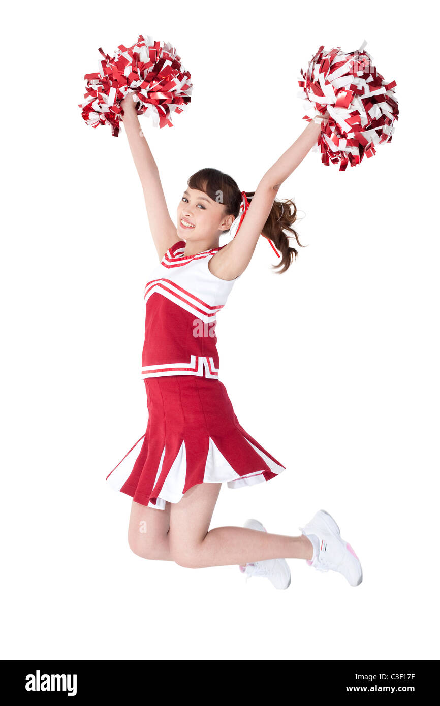Cheerleader in action with her pom-poms Stock Photo - Alamy