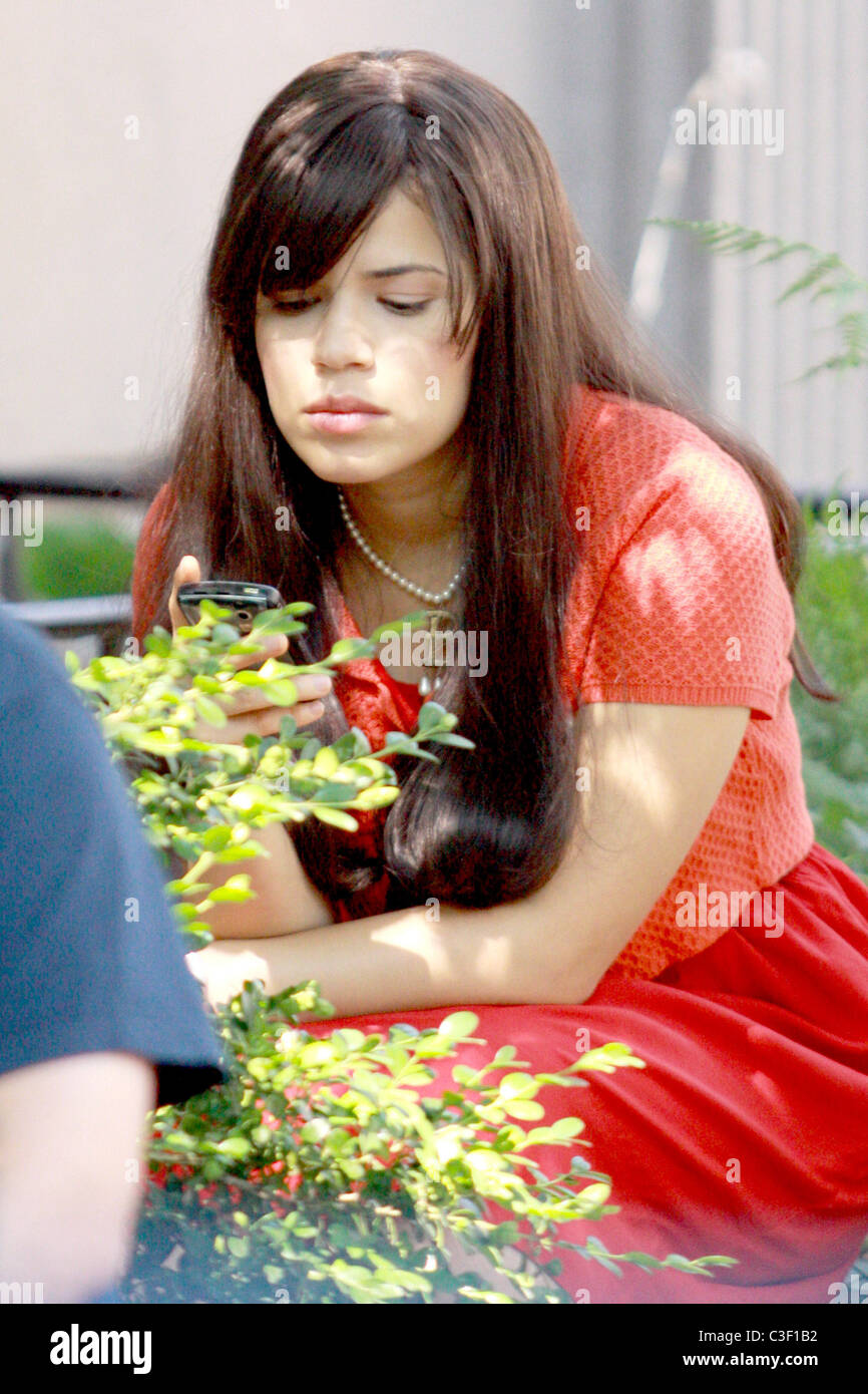America Ferrera checks her cell phone during a break from filming her ...