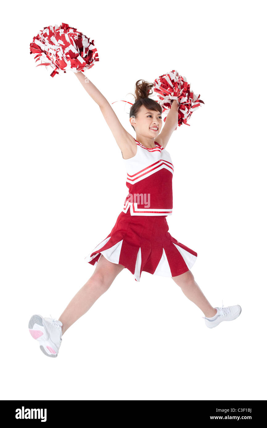 Cheerleader in action with her pom-poms Stock Photo - Alamy