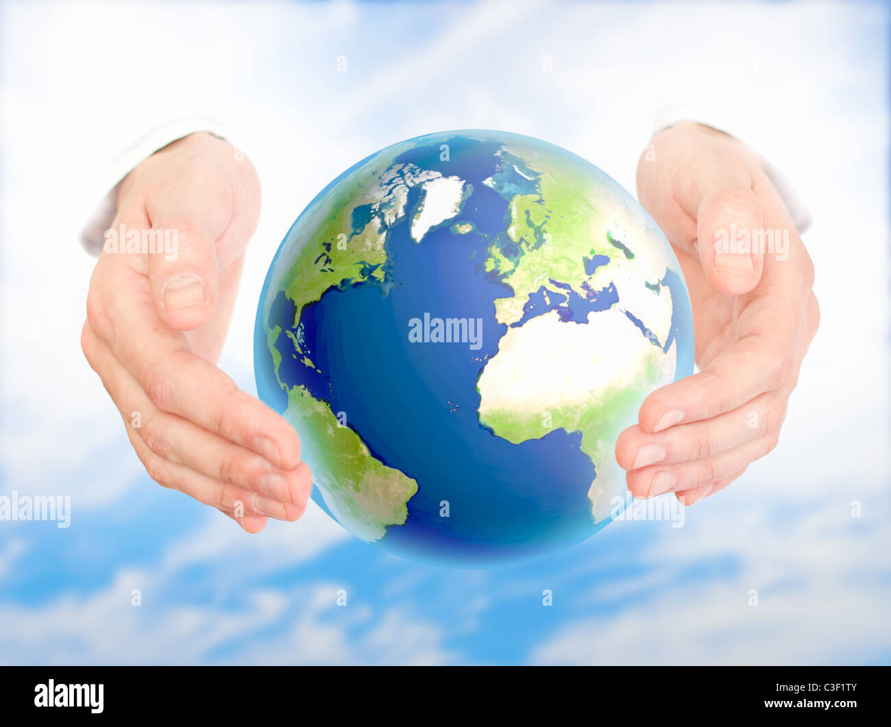 Earth in human hand against blue sky. Environmental protection concept ...