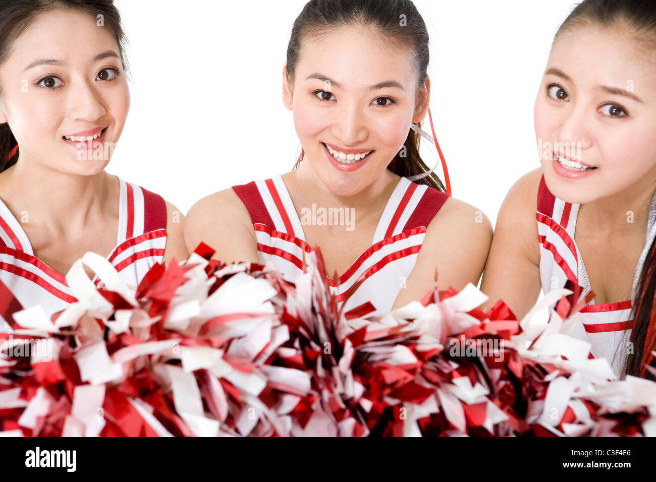 Portrait of three cheerleaders Stock Photo - Alamy