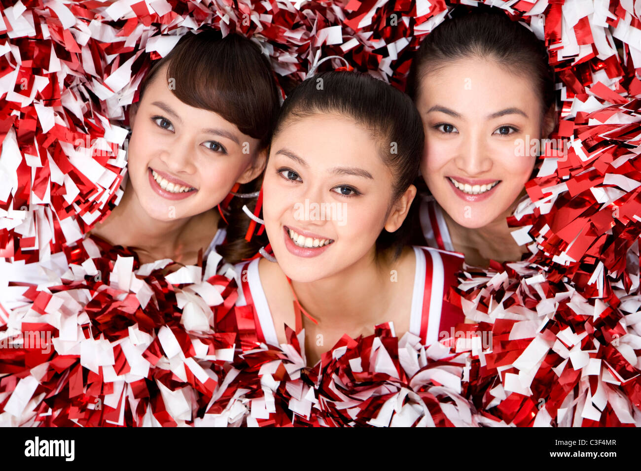 Portrait of three cheerleaders Stock Photo - Alamy