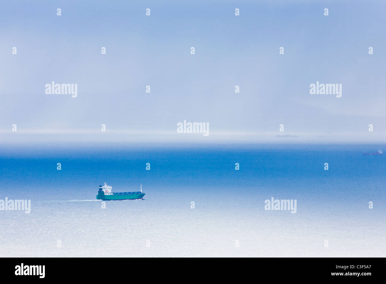 Cargo ship on its way to the sea Stock Photo - Alamy