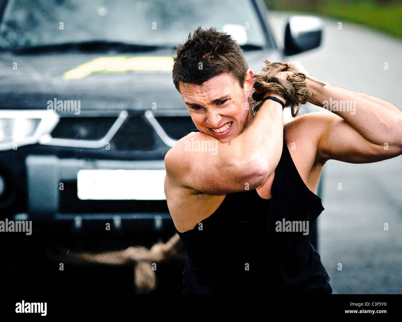 Man pulling truck Stock Photo - Alamy