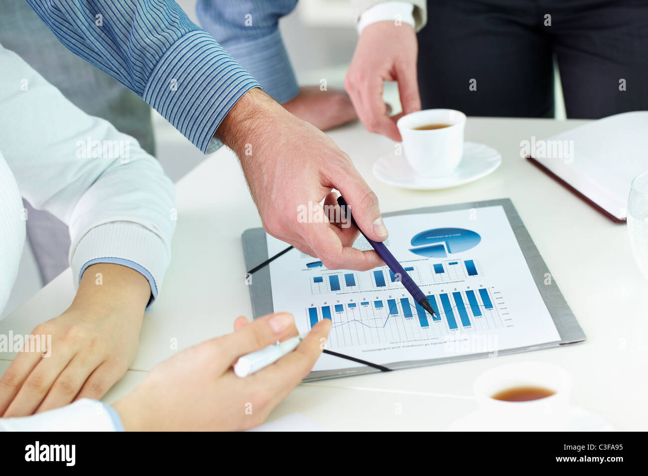 Image of human hand pointing at paper during explanation Stock Photo ...