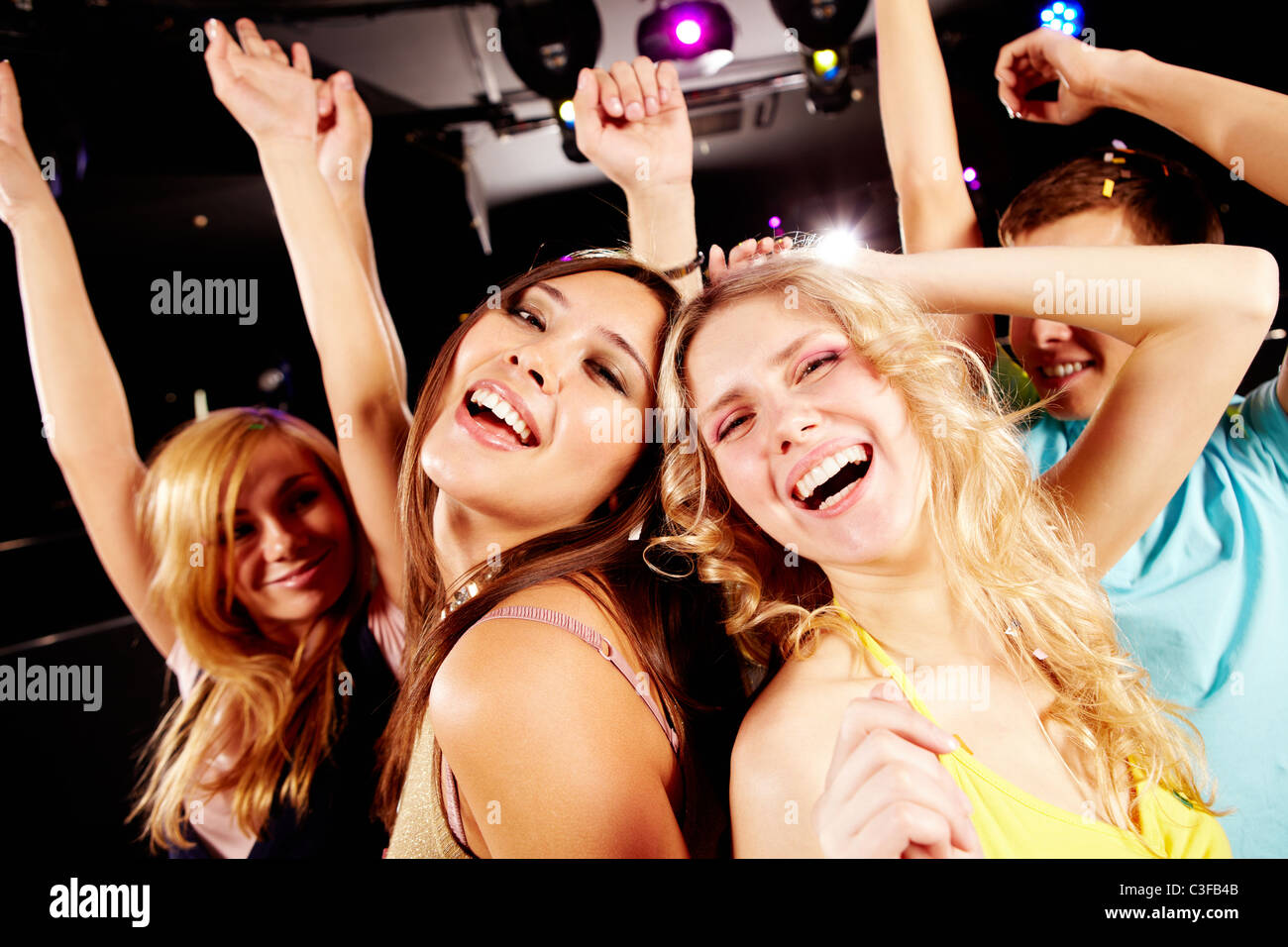 Two joyful girls dancing in night club and having fun Stock Photo - Alamy