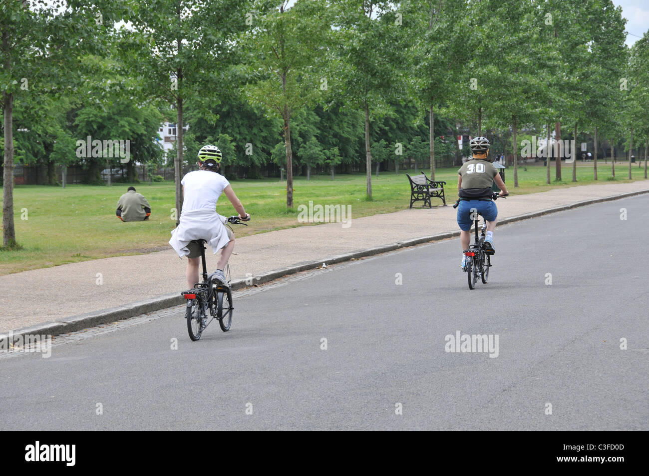 two men cycling keep fit exercise fitness training exercising pedalling ...