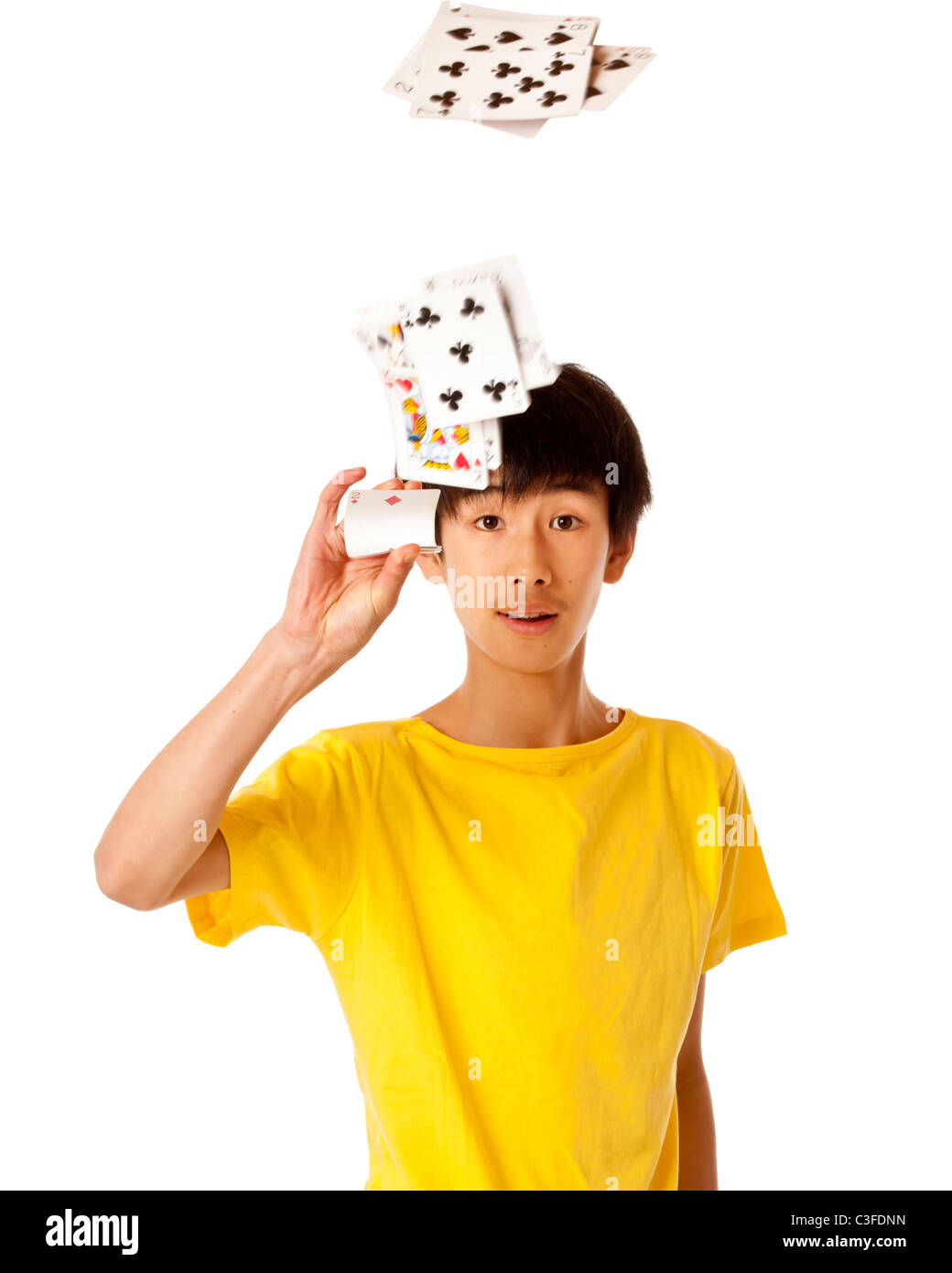teenage Chinese Asian boy flicking deck of cards into air against white ...