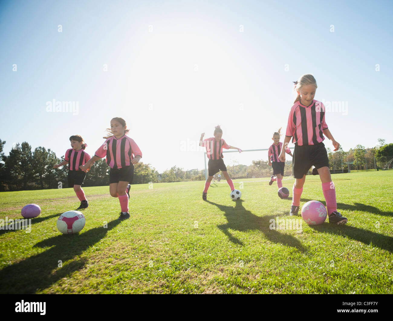 Girl soccer players practicing with soccer balls Stock Photo - Alamy