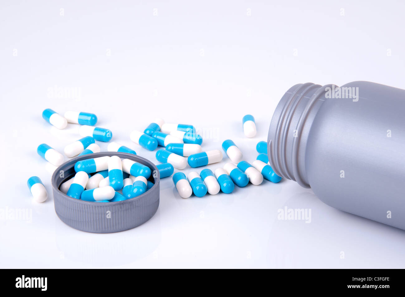 plastic container with medicine in blue and white capsules Stock Photo ...