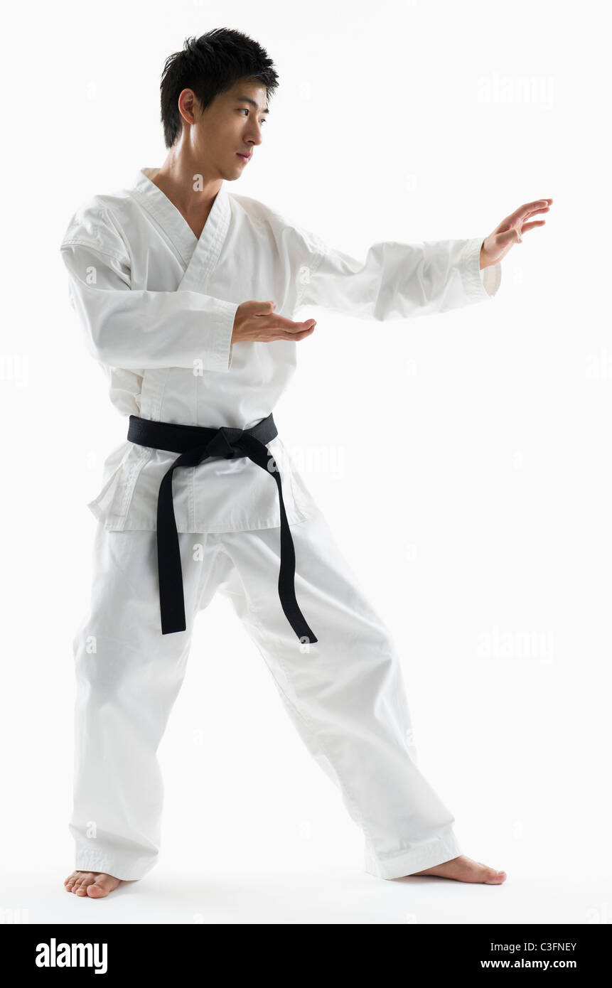 Young man practicing karate Cut Out Stock Images & Pictures - Alamy