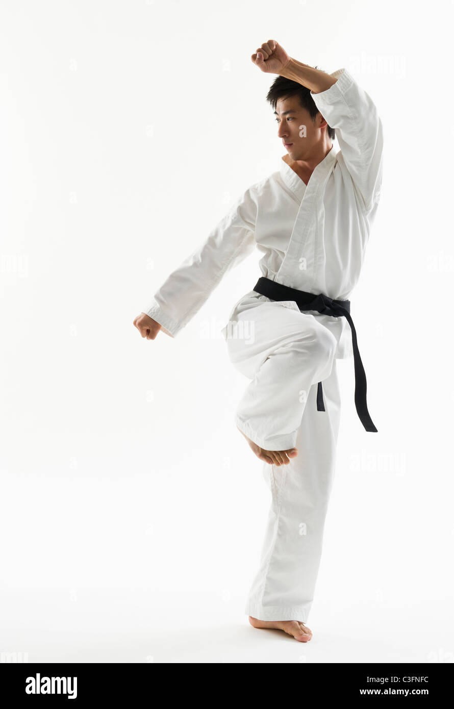 Asian male black belt practicing karate Stock Photo - Alamy