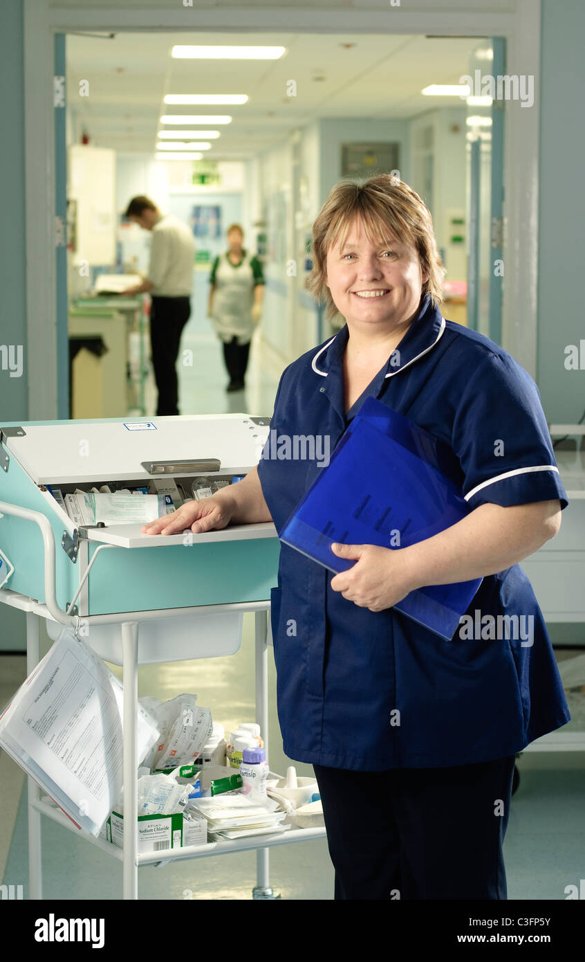 A British Female Ward Sister Nurse Stood In Corridor With A Drugs