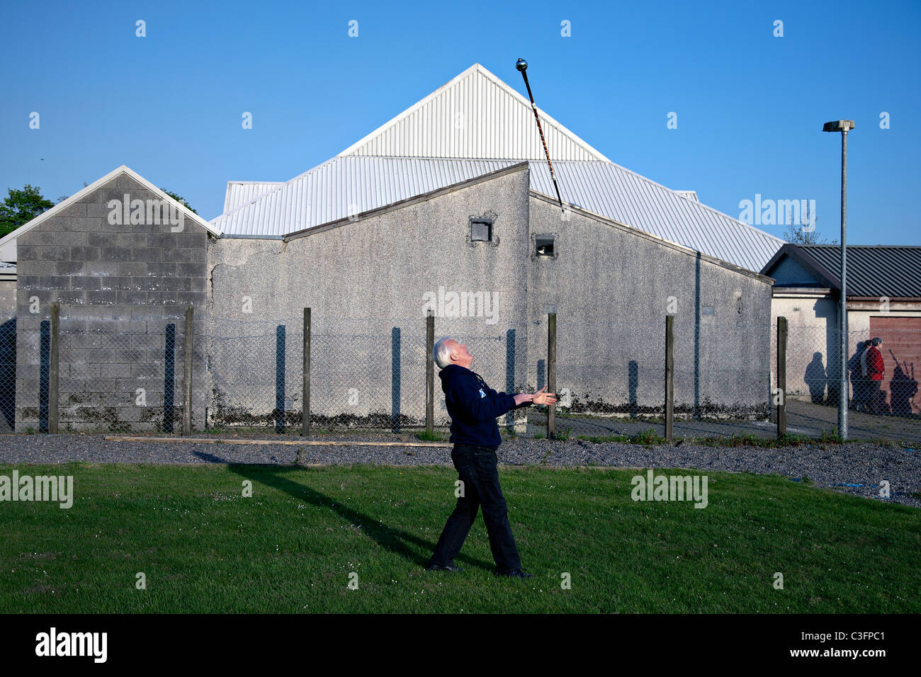 a scottish man throwing a baton in the air in Portree Sky Stock Photo ...