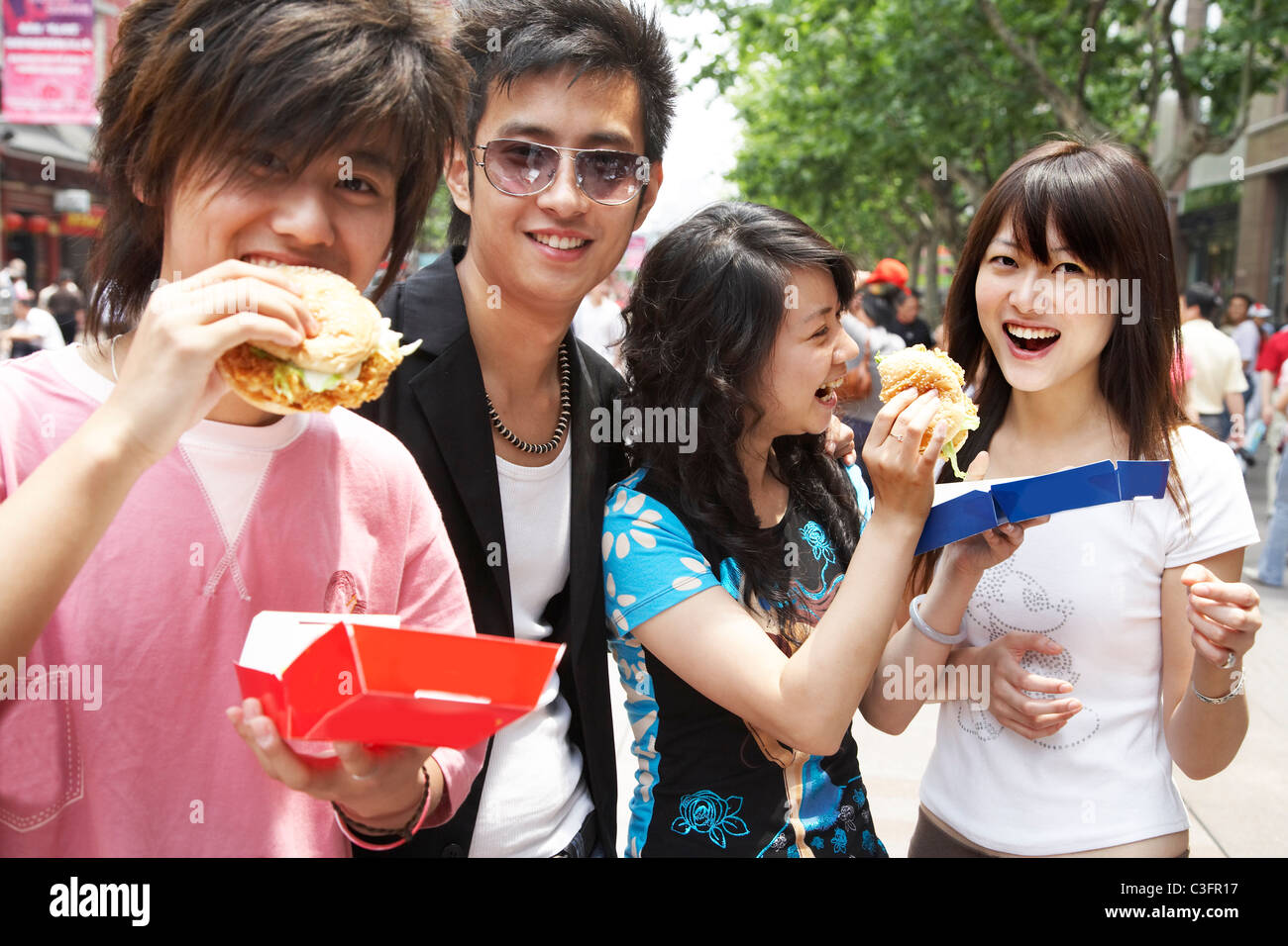 Chinese friends eating fast food together Stock Photo - Alamy
