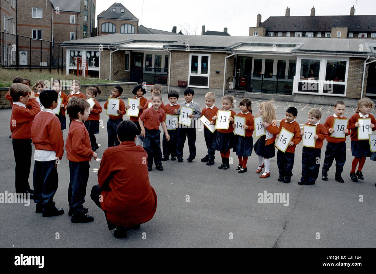 year one students in primary school playground playing with numbered ...