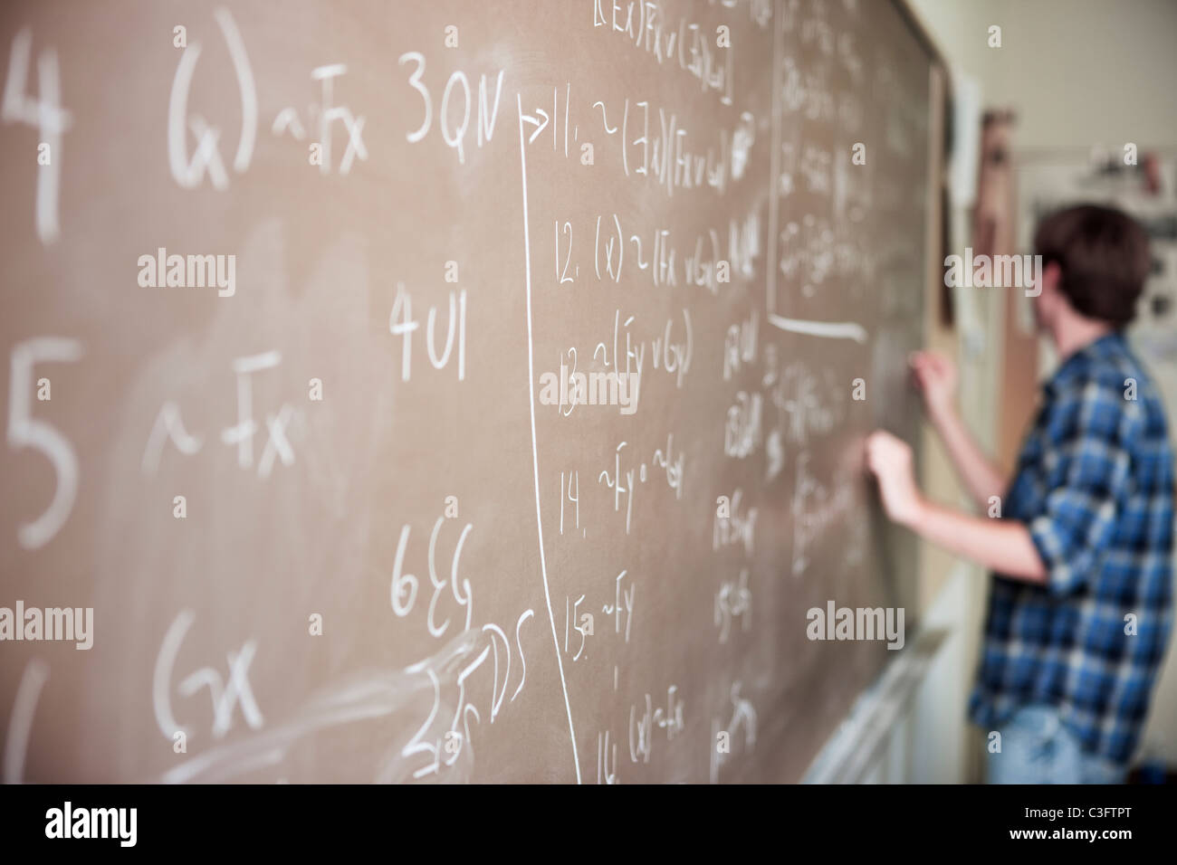 Caucasian student writing on blackboard Stock Photo - Alamy