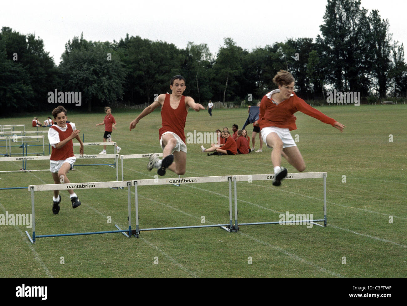 Secondary school sports day with boys hurdle racing Stock Photo - Alamy