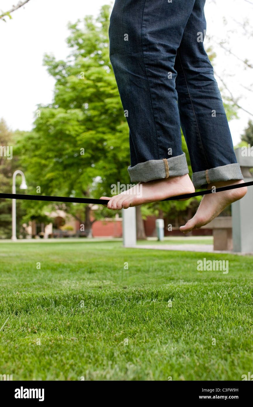 Caucasian man balancing on rope in park Stock Photo - Alamy