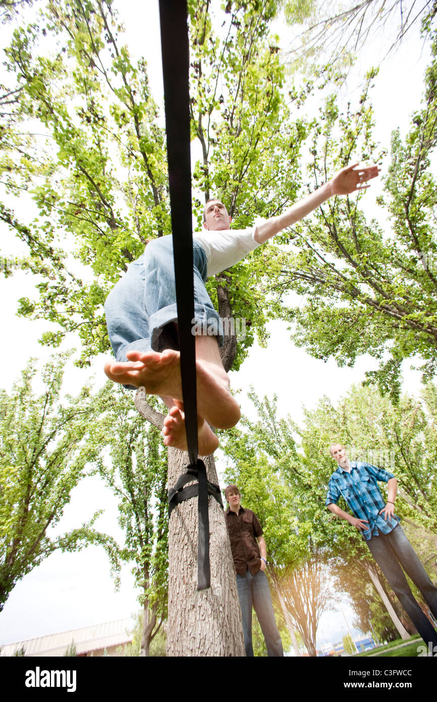 Caucasian man balancing on rope in park Stock Photo - Alamy