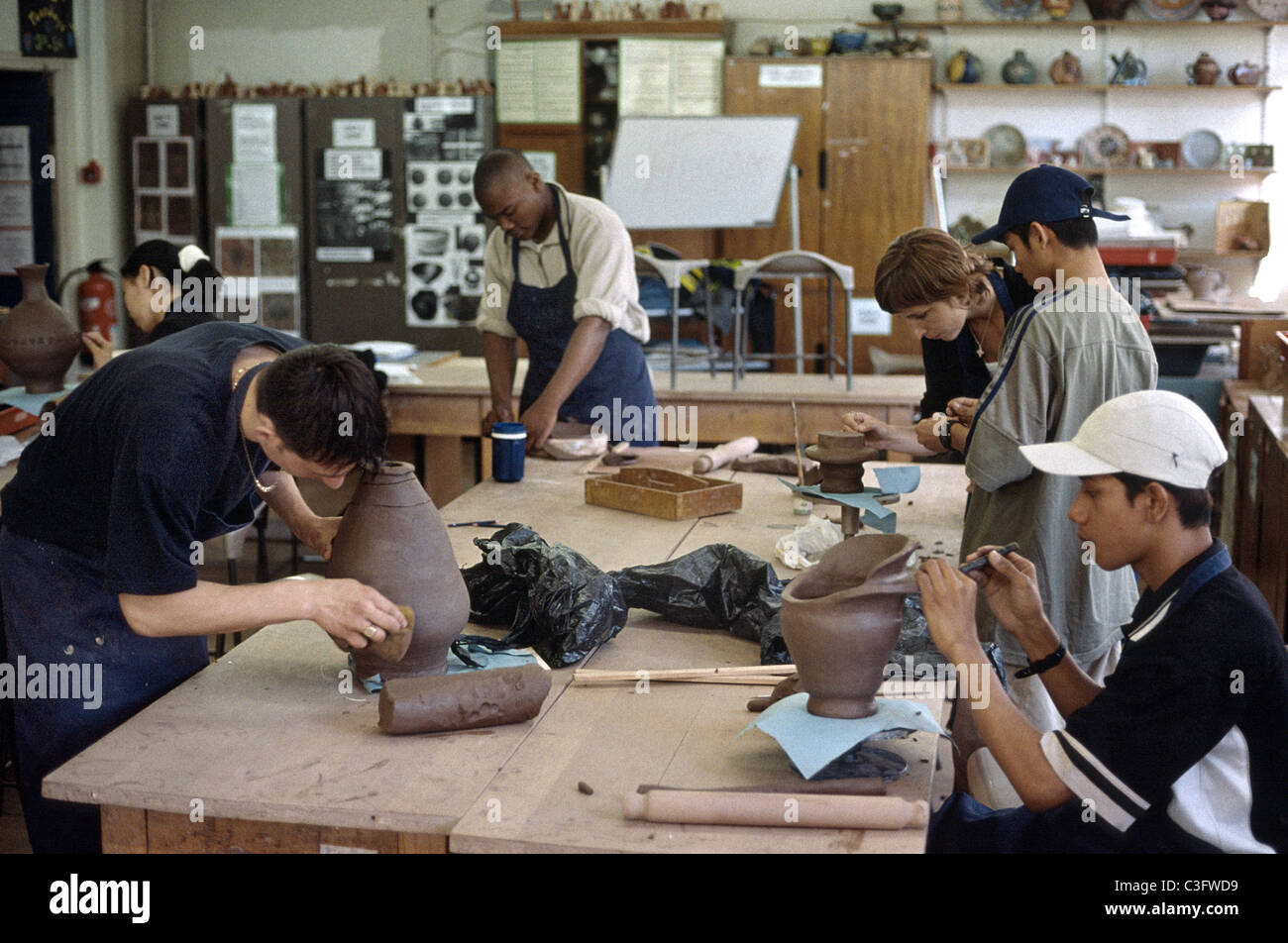 secondary school classroom scene showing students working with clay ...