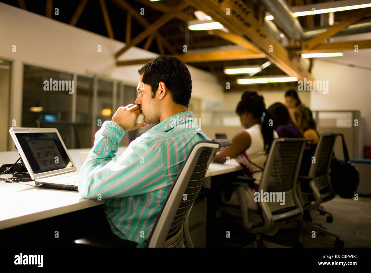 Business people working on communal workspace Stock Photo - Alamy