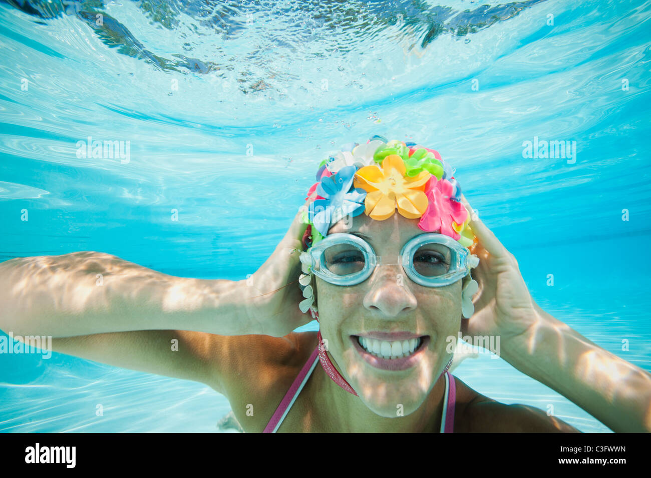 Hispanic woman in retro swimming cap underwater in swimming pool Stock ...