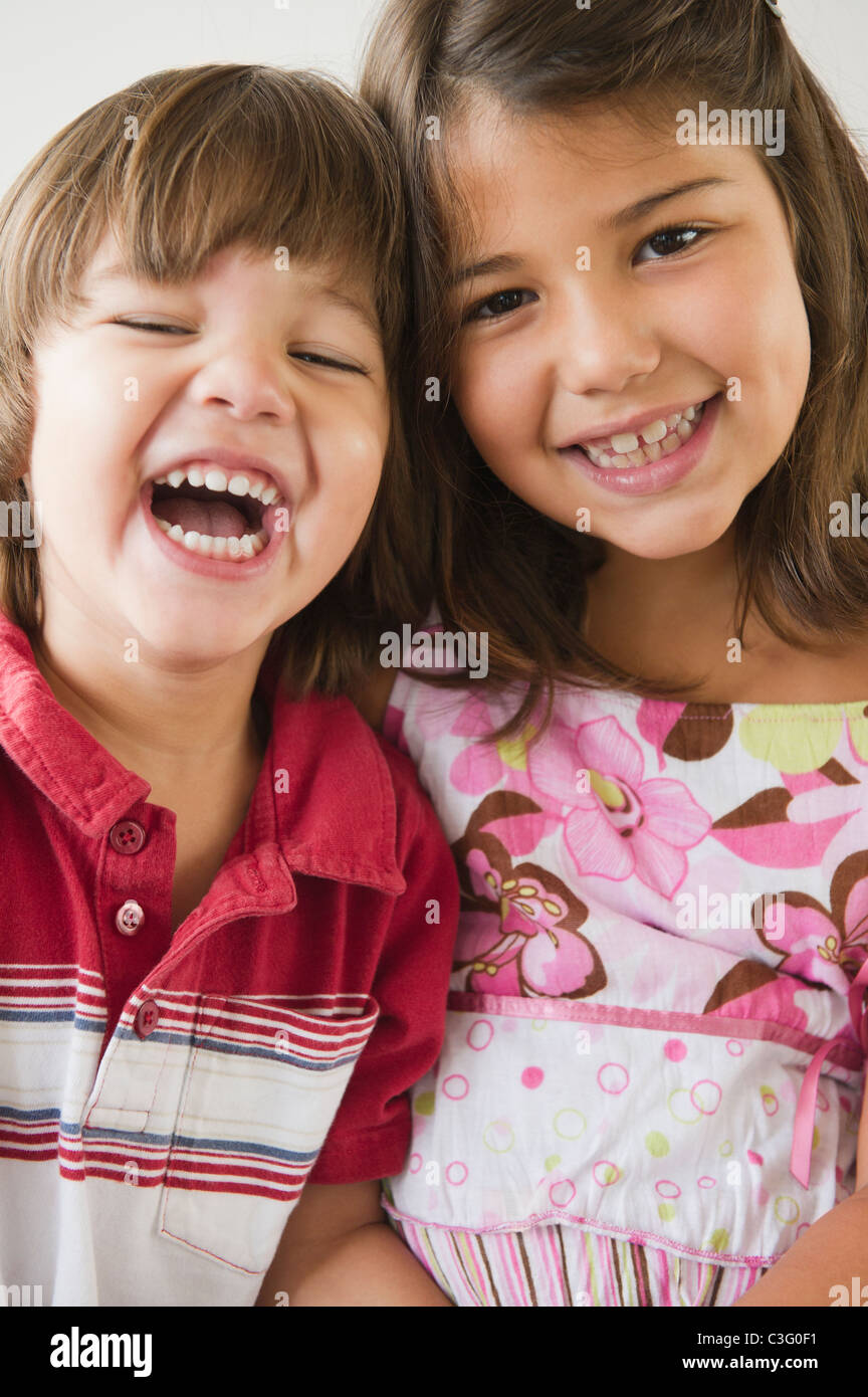 Hispanic brother and sister smiling Stock Photo - Alamy