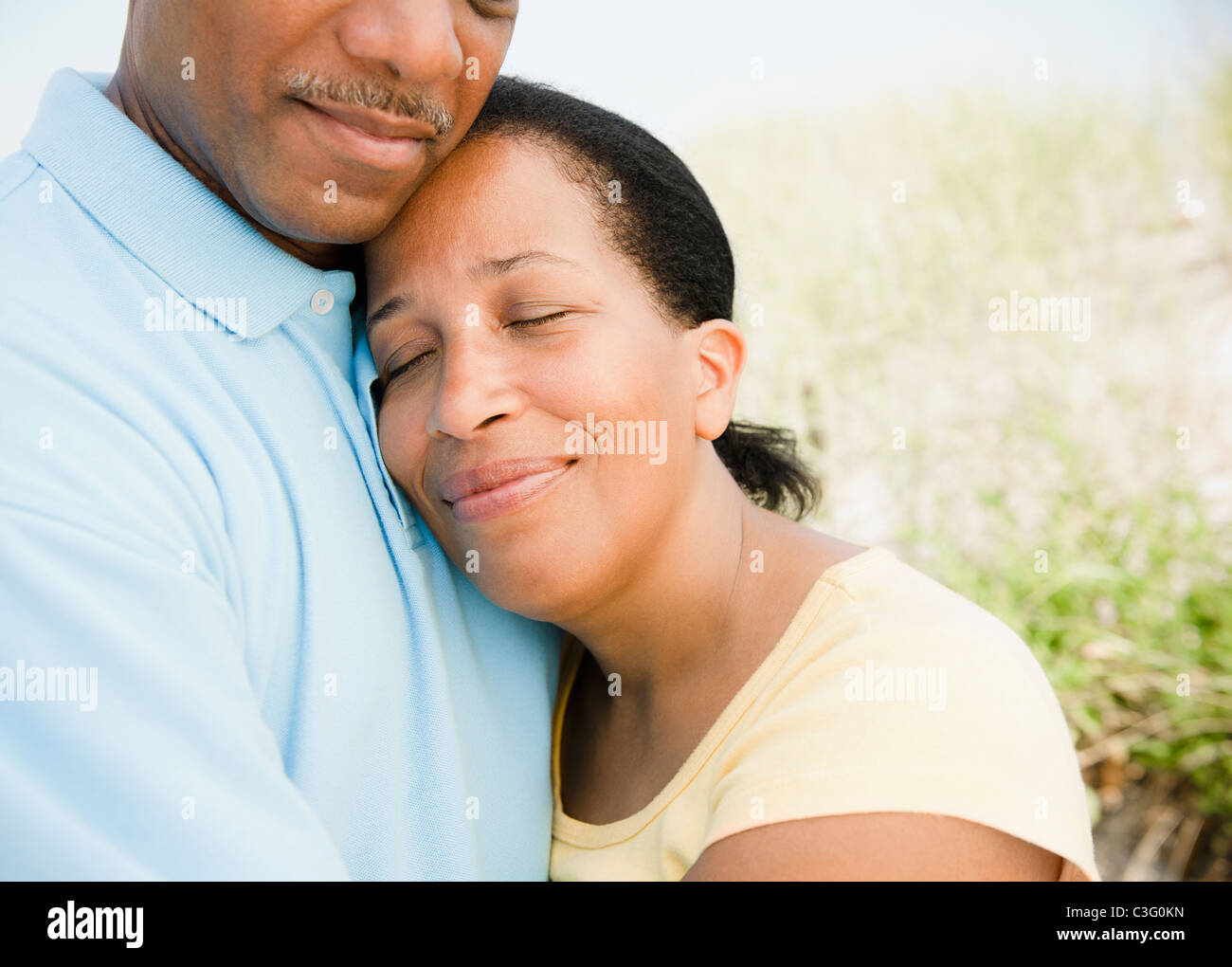 Black couple hugging Stock Photo - Alamy