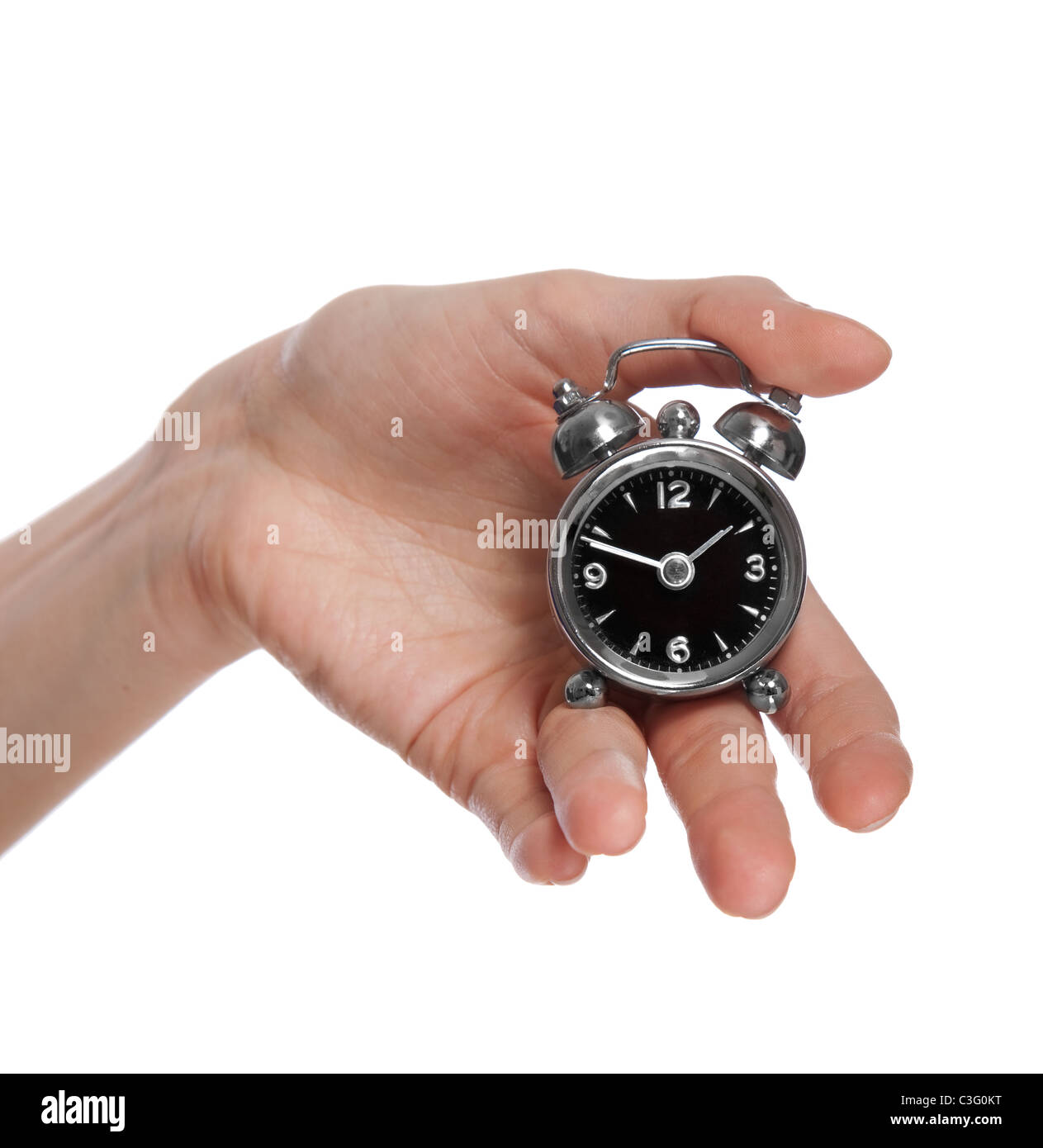 female hand holding a small alarm clock, isolated on white Stock Photo ...