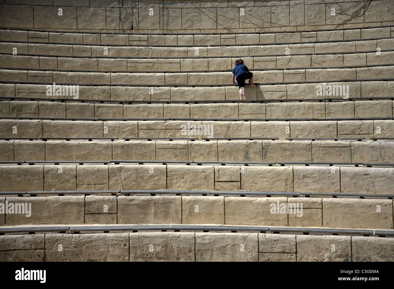 a young boy climbing up steep steps Stock Photo - Alamy