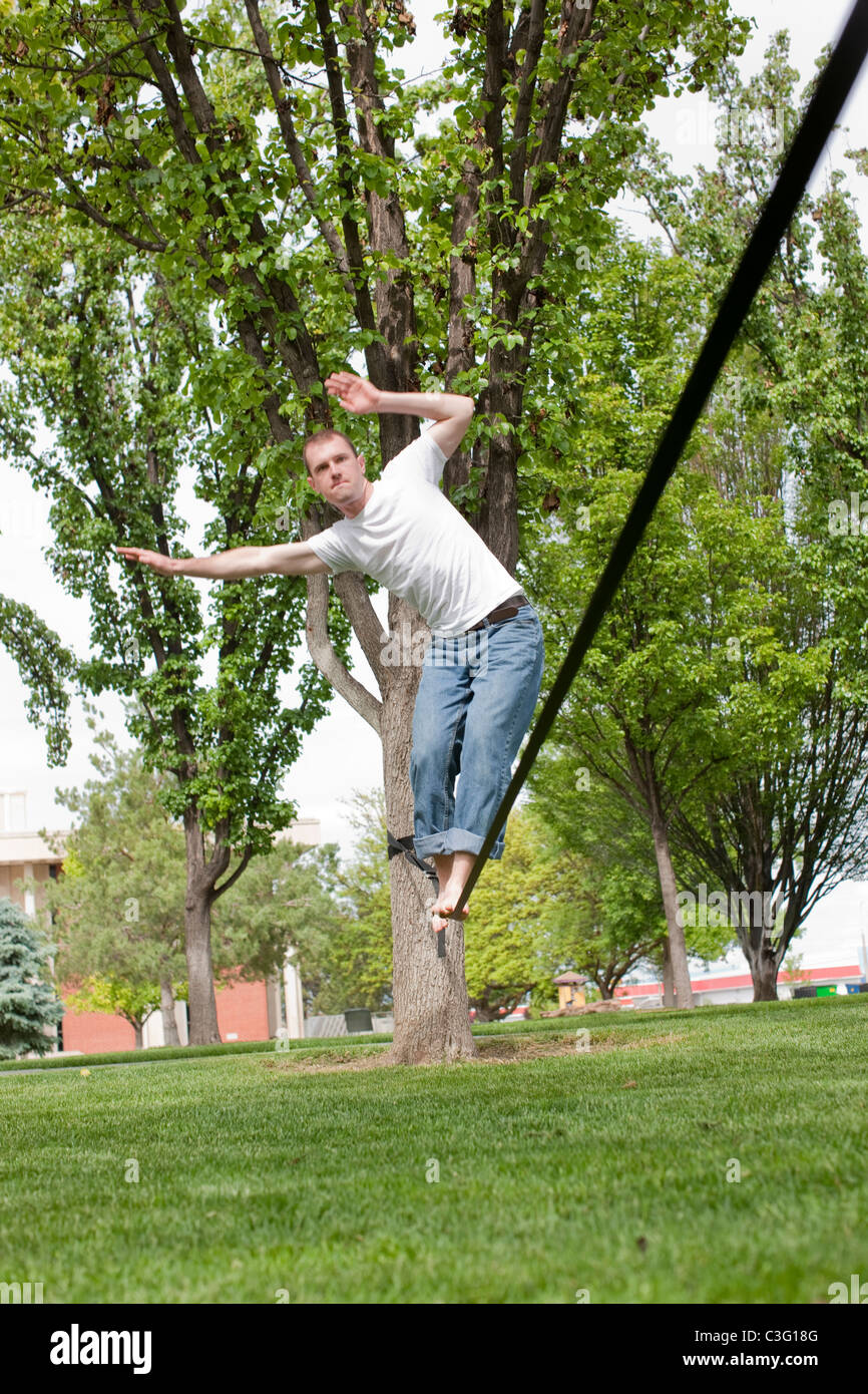 Caucasian man balancing on rope in park Stock Photo - Alamy
