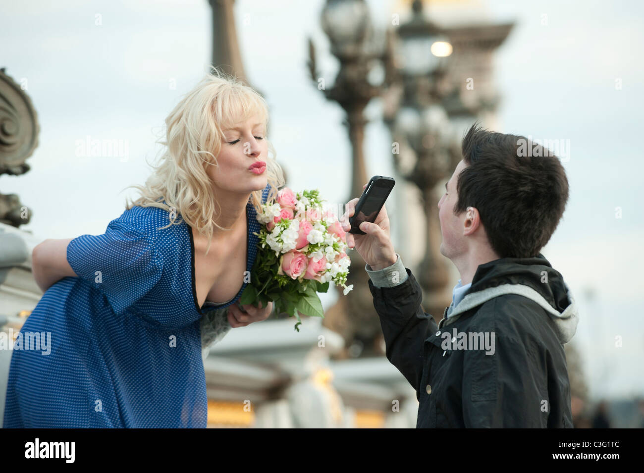 Caucasian man photographing girlfriend Stock Photo - Alamy