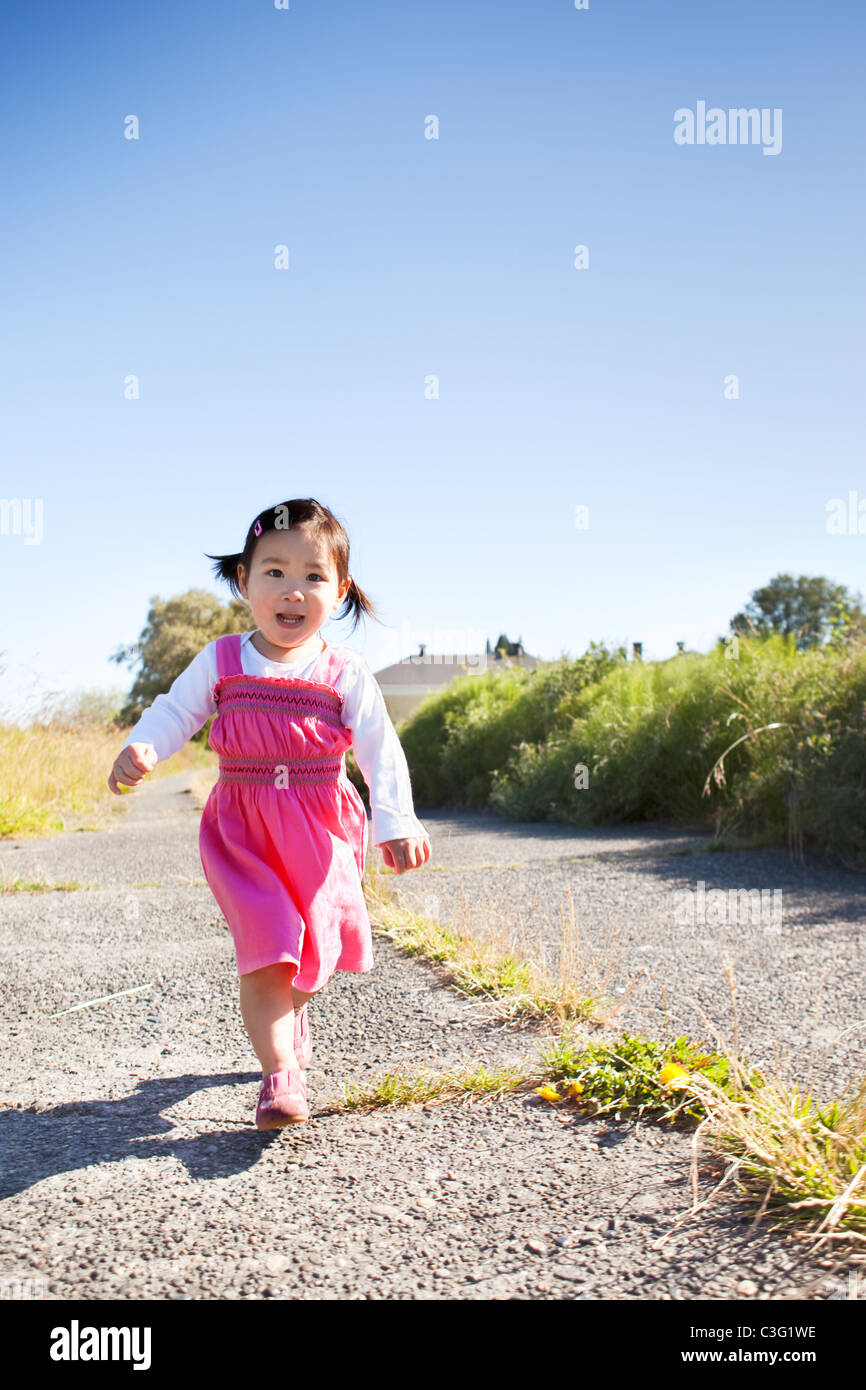 Chinese girl running on path Stock Photo - Alamy
