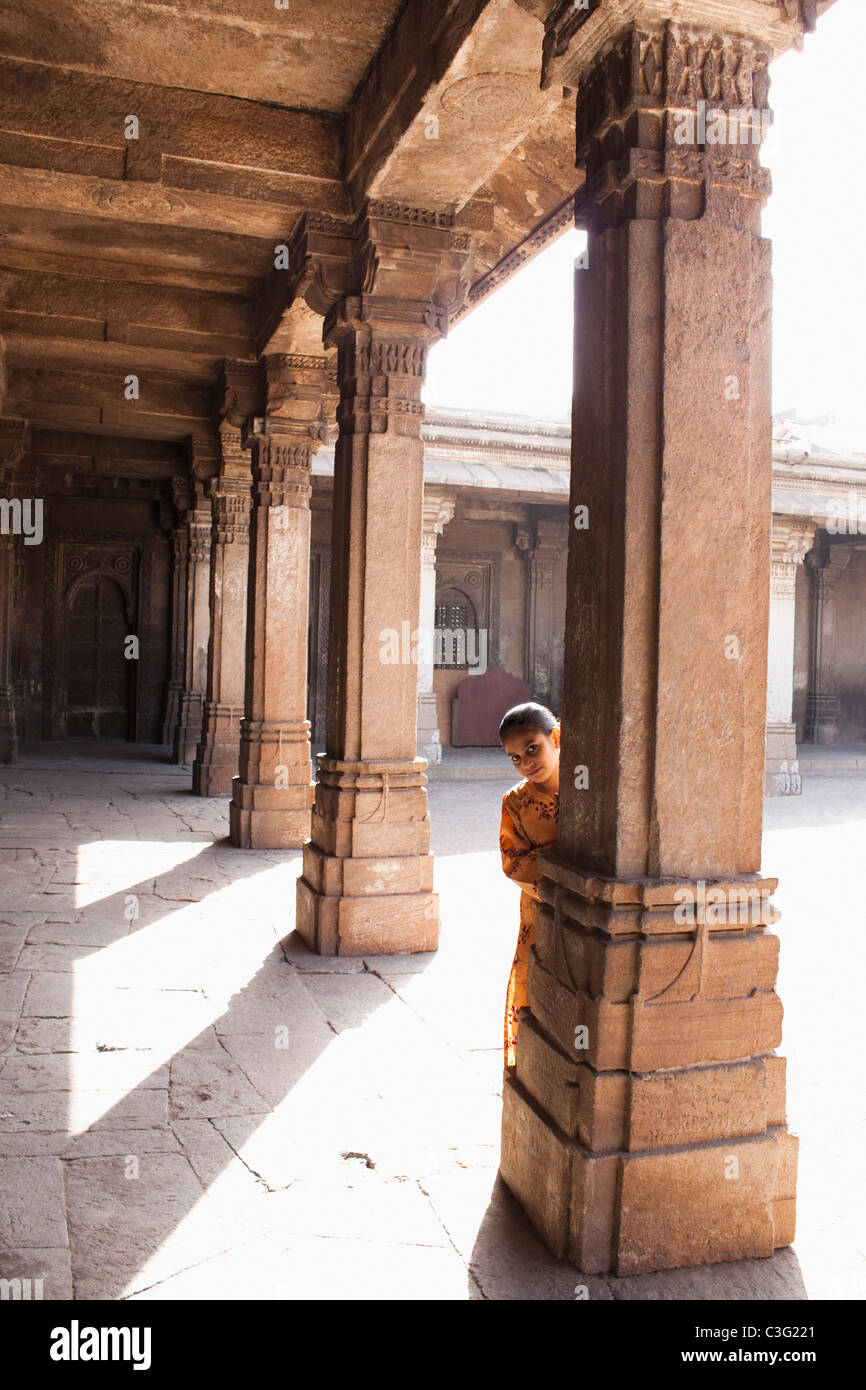 Girl standing behind a column, Ahmedabad, Gujarat, India Stock Photo ...
