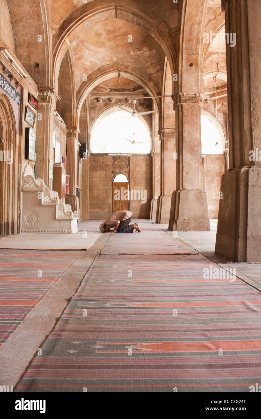 Man praying in a mosque, Siddi Sayed Mosque, Ahmedabad, Gujarat, India ...