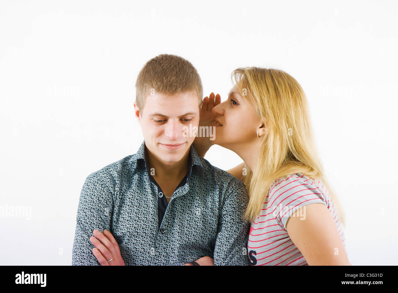 The girl silently tells something to the young man Stock Photo - Alamy