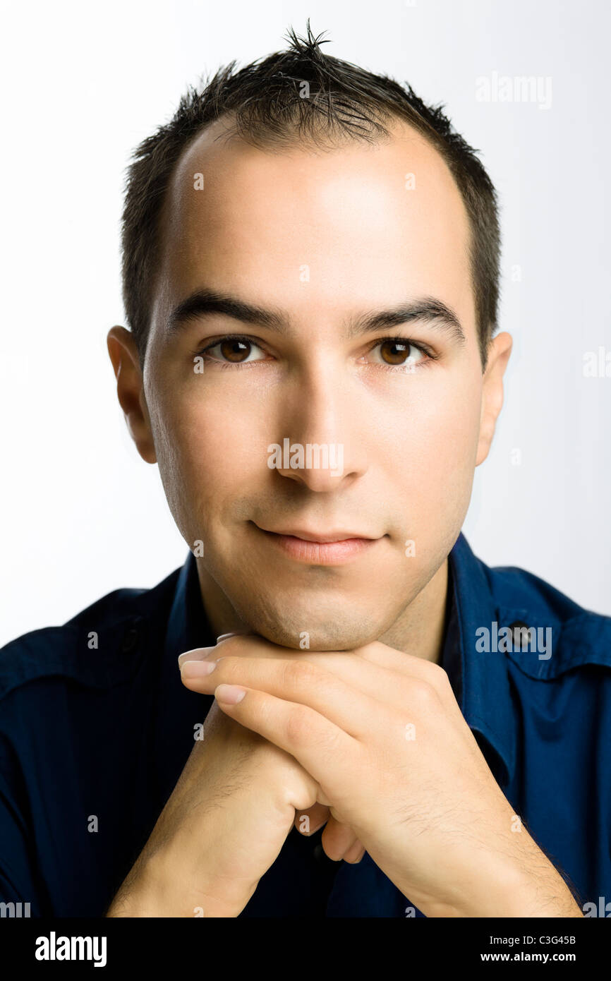 Serious Caucasian man with hands on chin Stock Photo - Alamy
