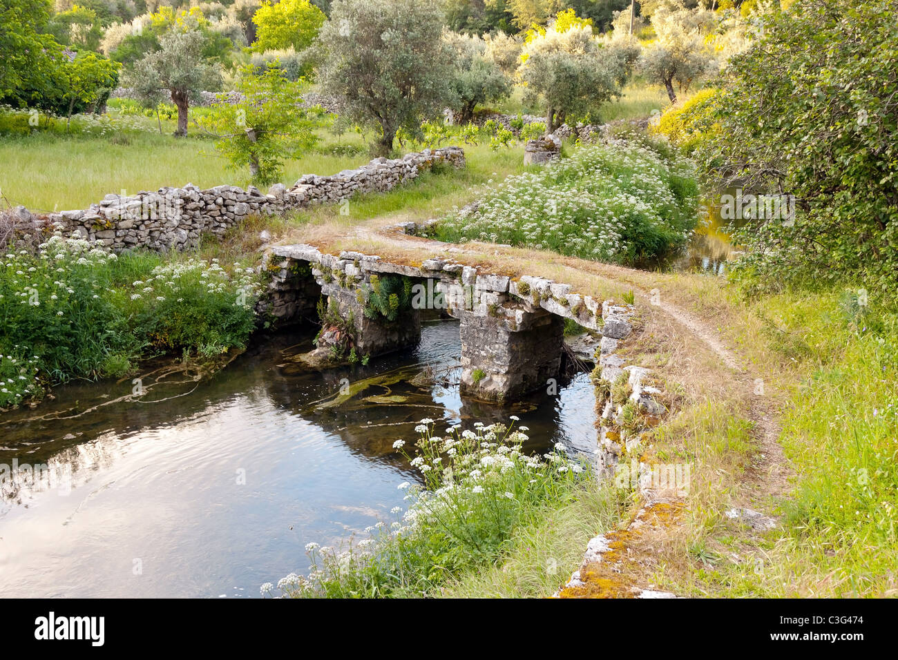 Stone bridge over small river against rural landscape Stock Photo - Alamy