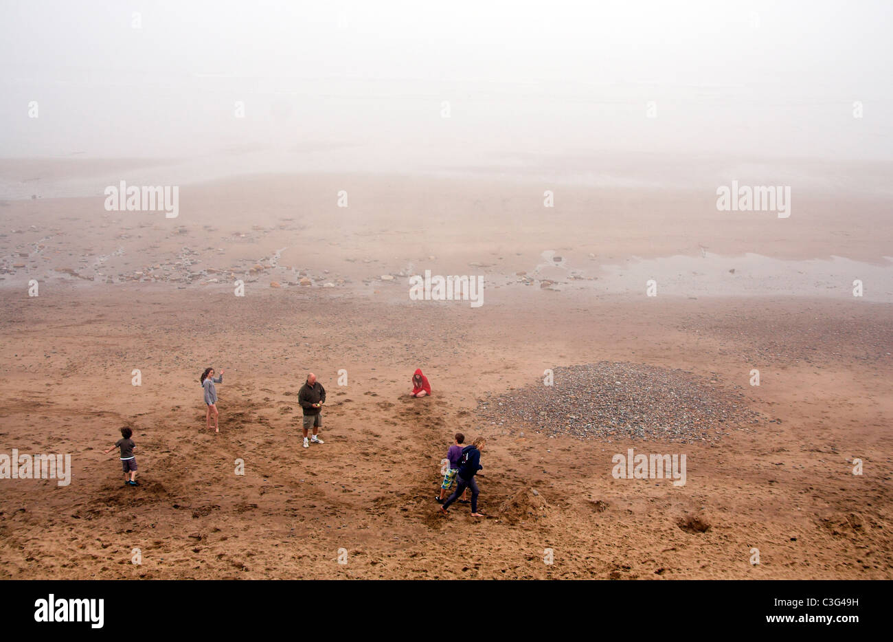 Families at the seaside despite the bad weather, Sandsend Beach, near ...
