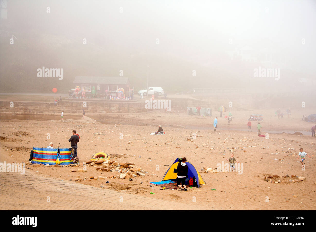 Families at the seaside despite the bad weather, Sandsend Beach, near ...