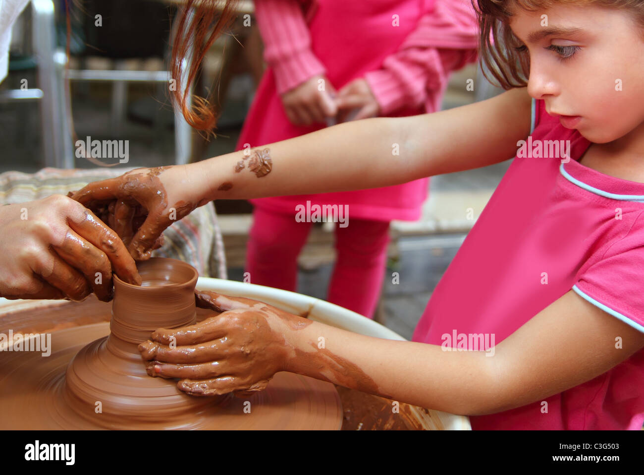 clay potter hands wheel pottery work workshop teacher and girl pupil ...