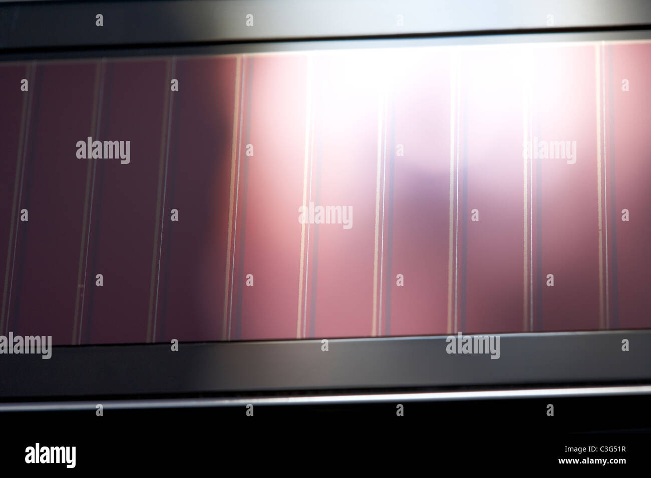 light falling on solar recharging panel on a small electrical device ...