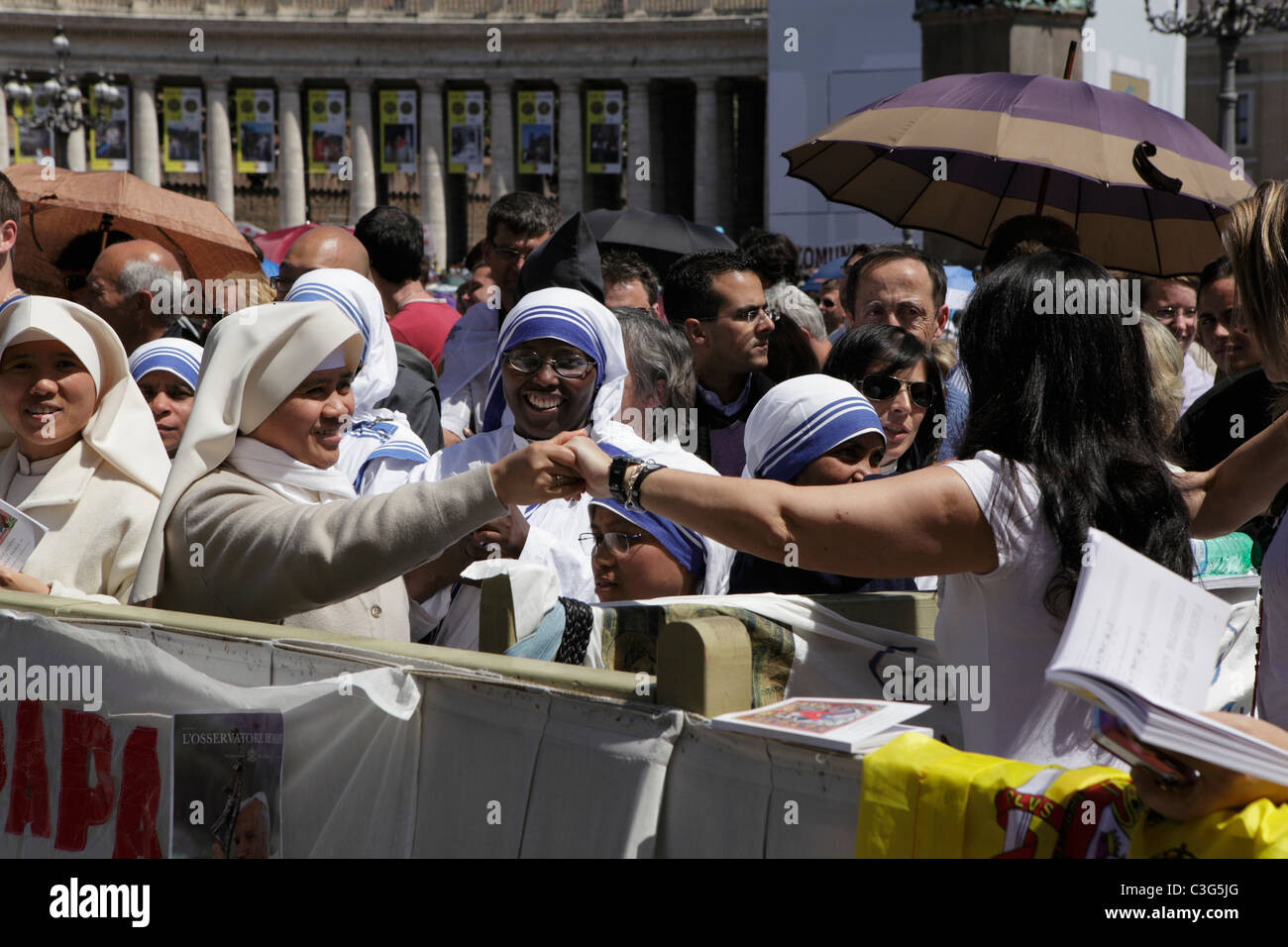 nuns exchanging greetings with other spectators at celebration for ...