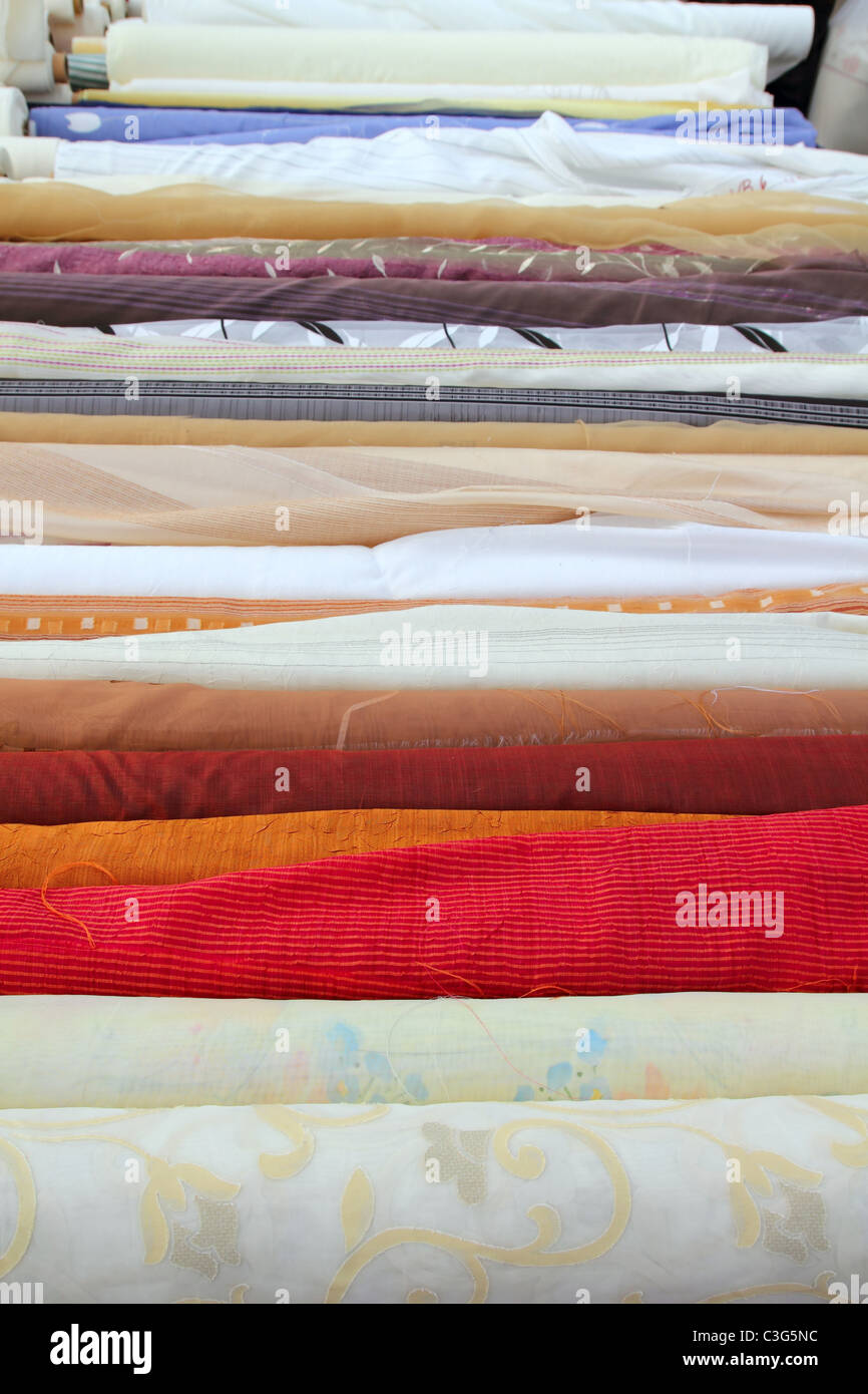 fashion fabric rolls in retail market shop pattern in a row Stock Photo ...
